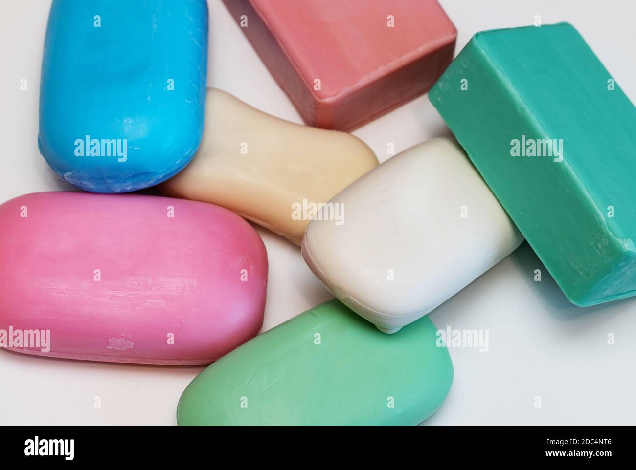 Background from bars of soap of different colors on a white table, top ...