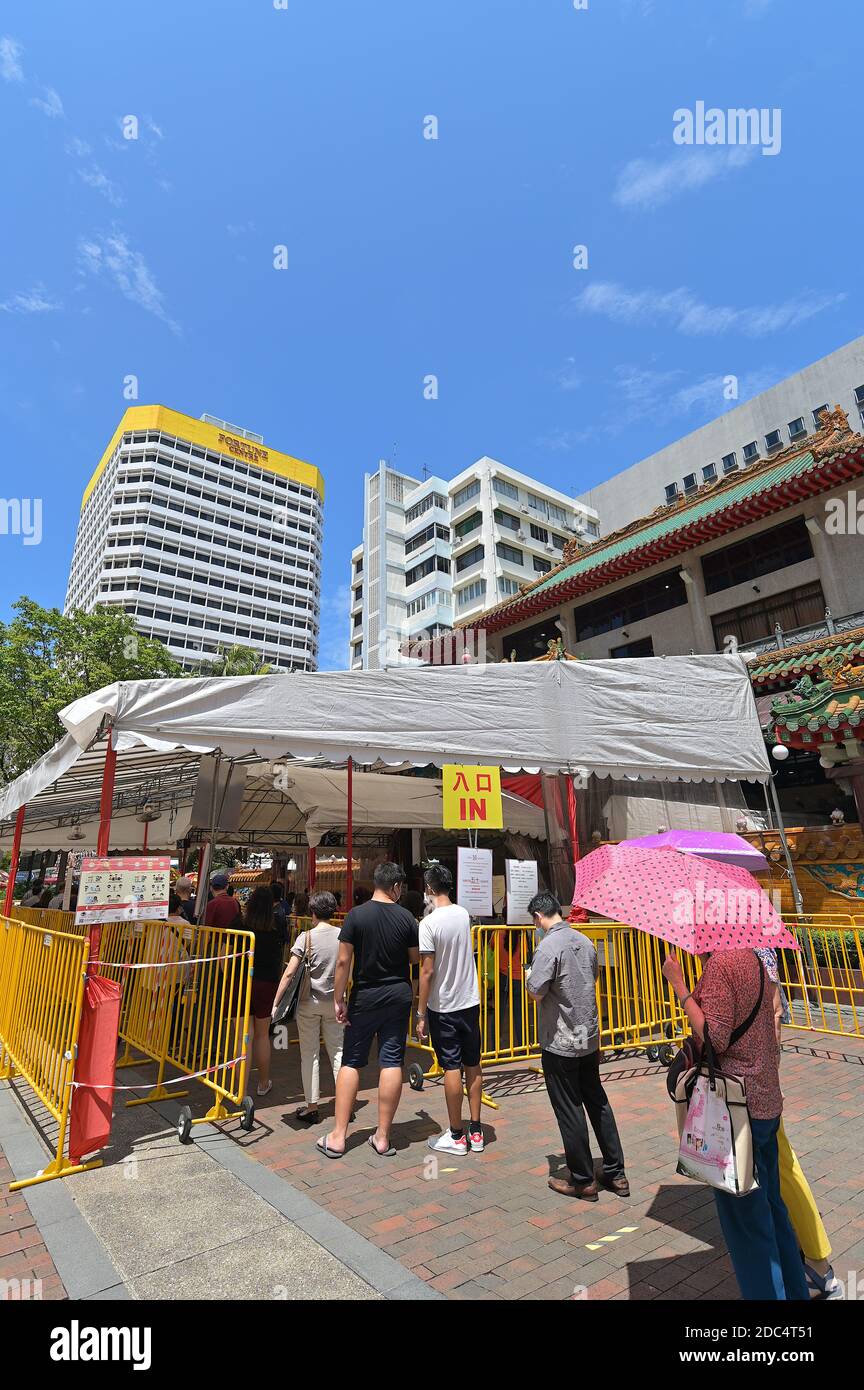 People making their way through crowd barriers to worship at the Kwan ...