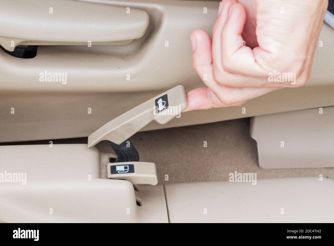 hand pulling trunk release button in a car. selective focus Stock Photo ...