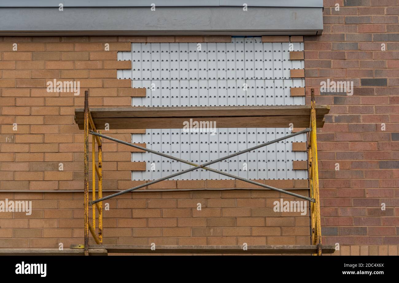 decorative rectangular pattern siding with brick veneer on a new strip ...