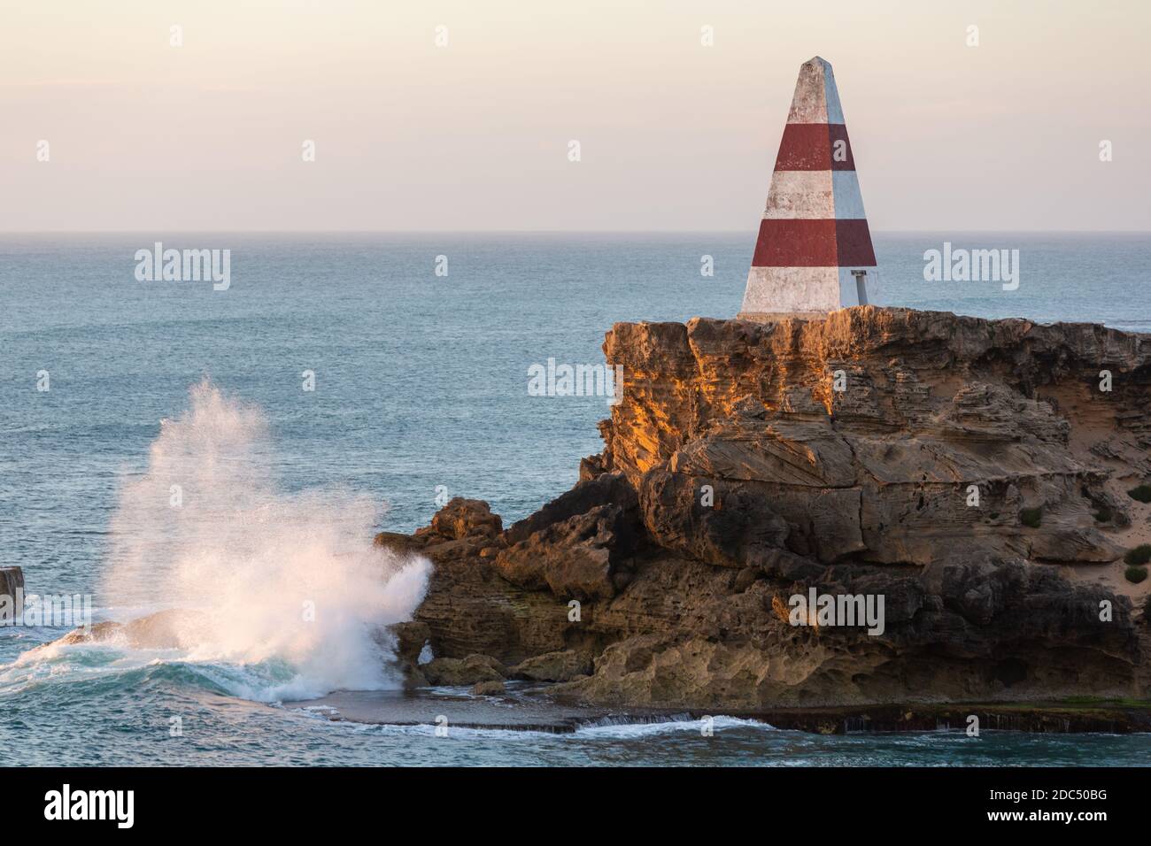 A large wave breaking below the iconic Obelisk built on now heavily ...