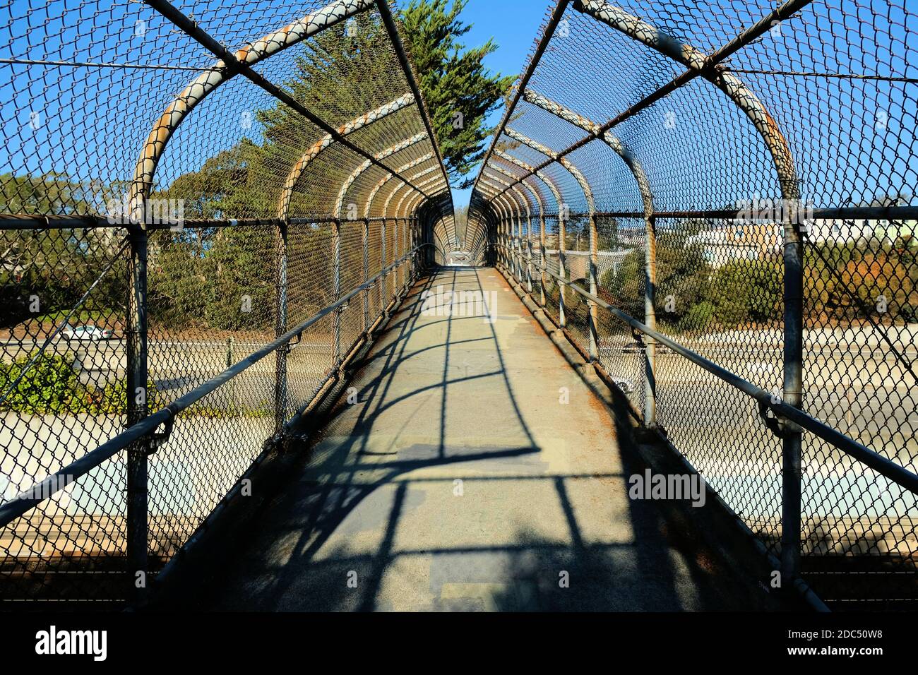 Tunnel view of a footbridge that allows pedestrians to cross over the ...
