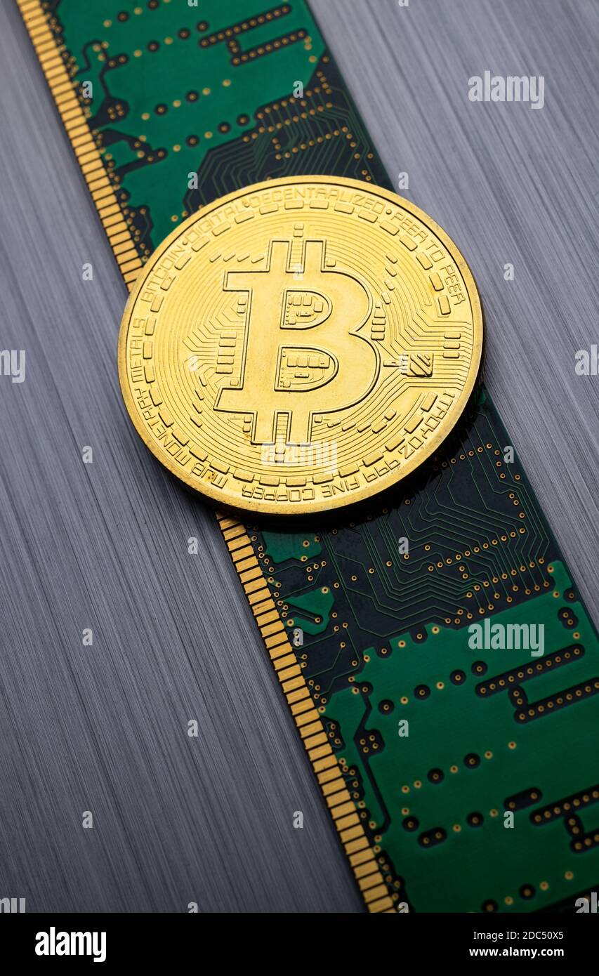 Bitcoin token coin on computer ram and brushed metal background ...