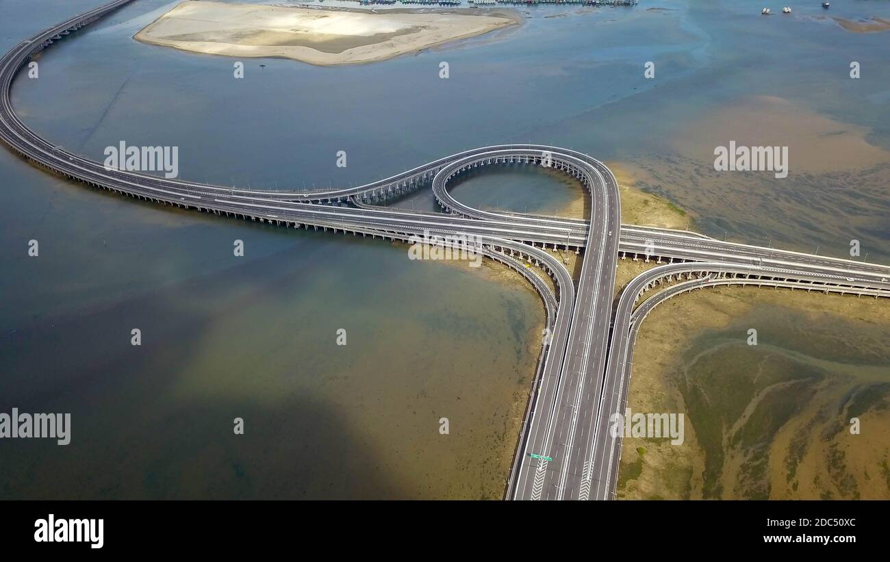 Aerial view of Bali Mandara toll road over sea on Bali island. Car ...