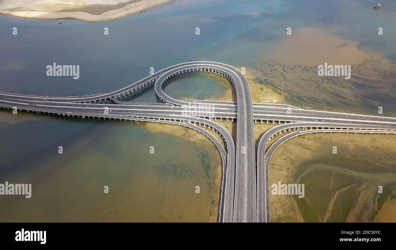 Aerial view of Bali Mandara toll road over sea on Bali island. Car ...