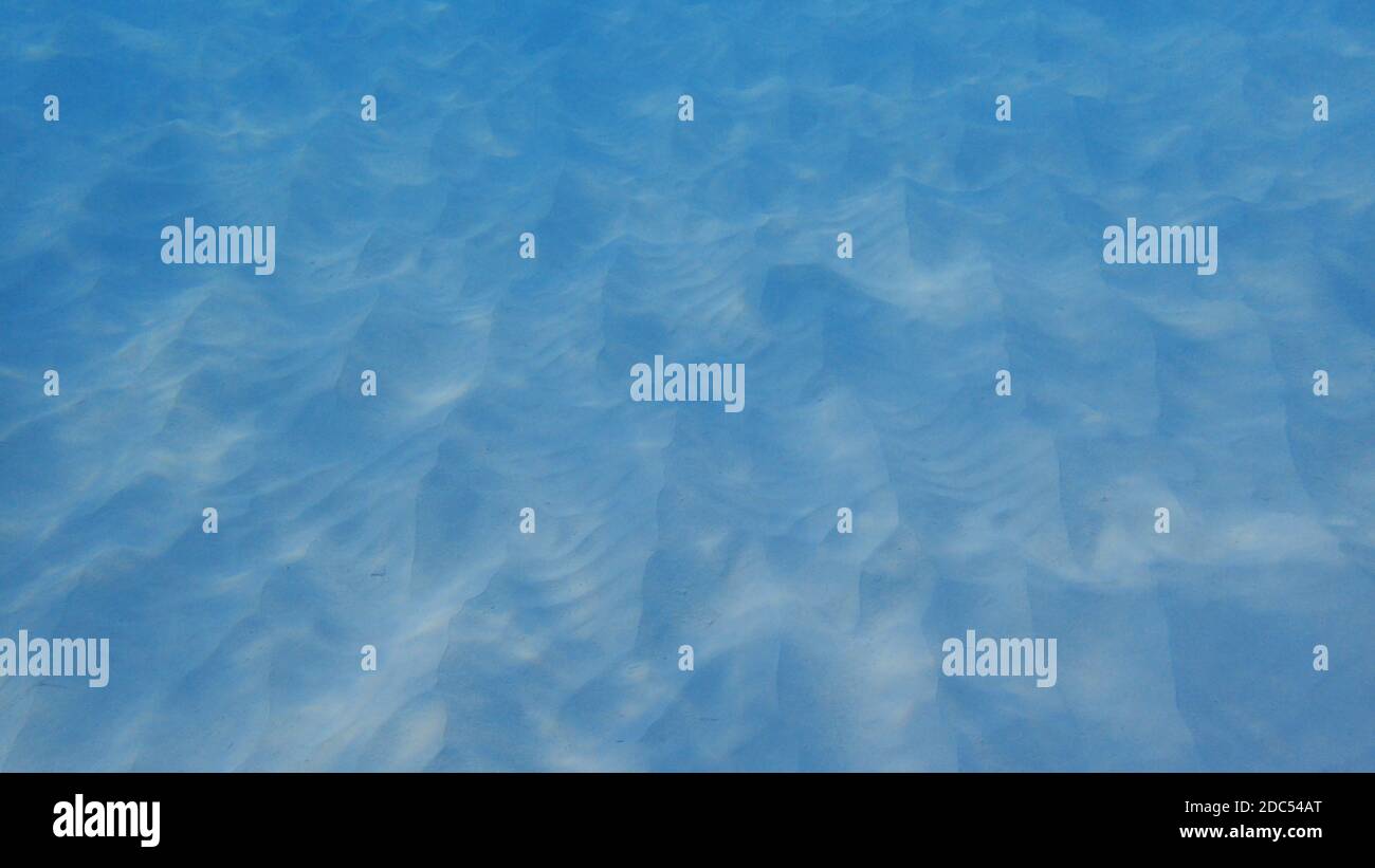 Sand underwater that the waves have formed a pattern that is unique ...