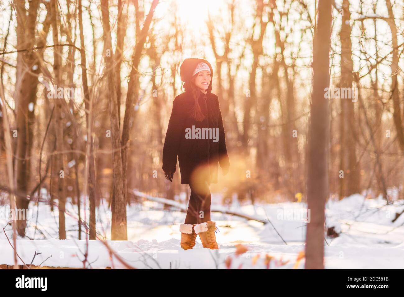 Winter outdoor activity healthy young Asian girl walking in woods ...