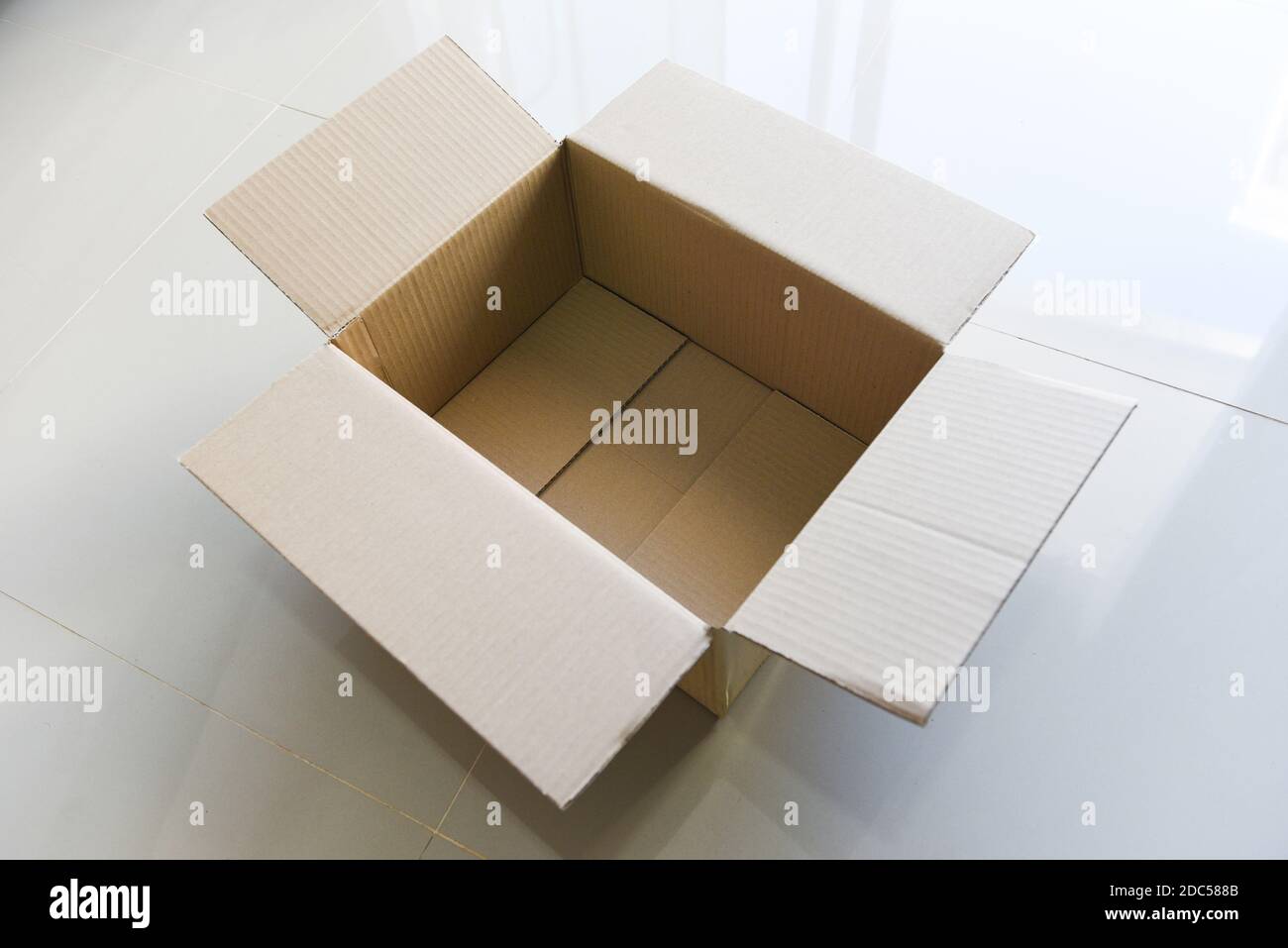 Open cardboard box on floor background, High angle view of an empty ...