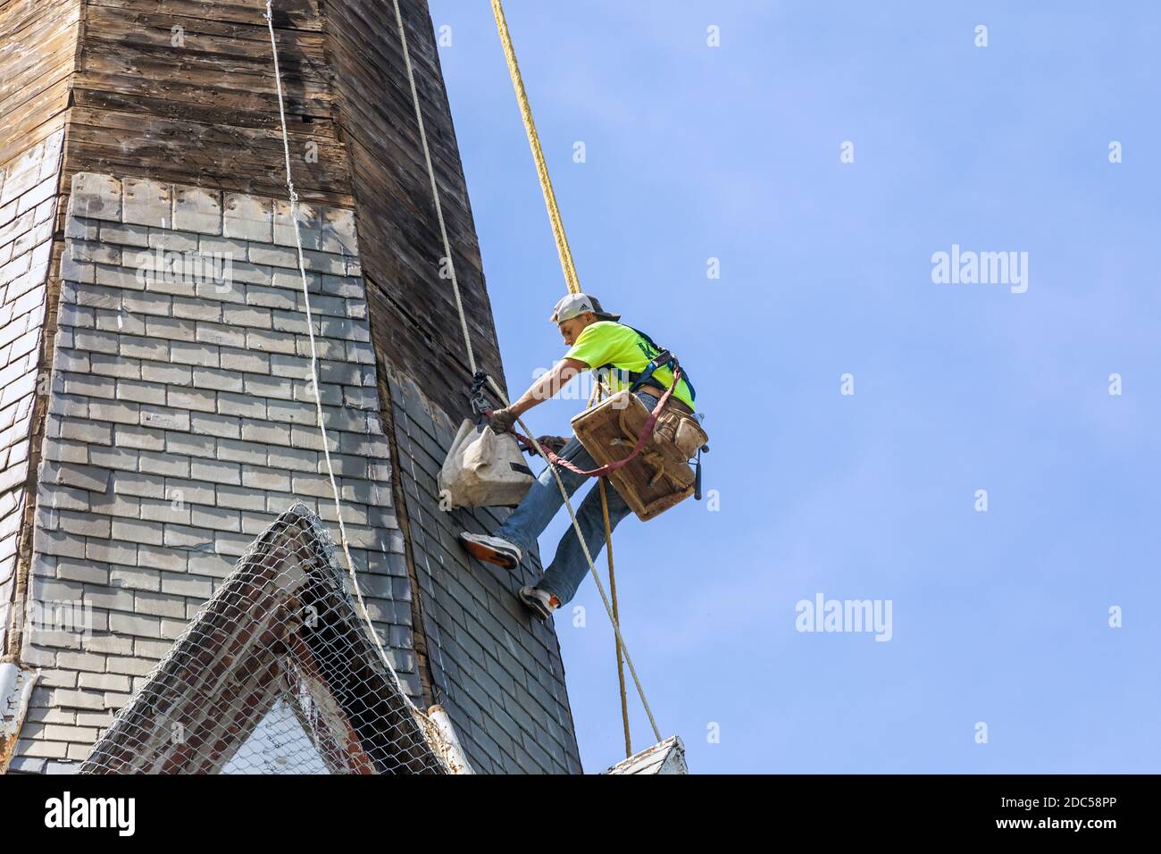 Workers repair the steeple of Saint John’s Church in Burlington, Iowa ...