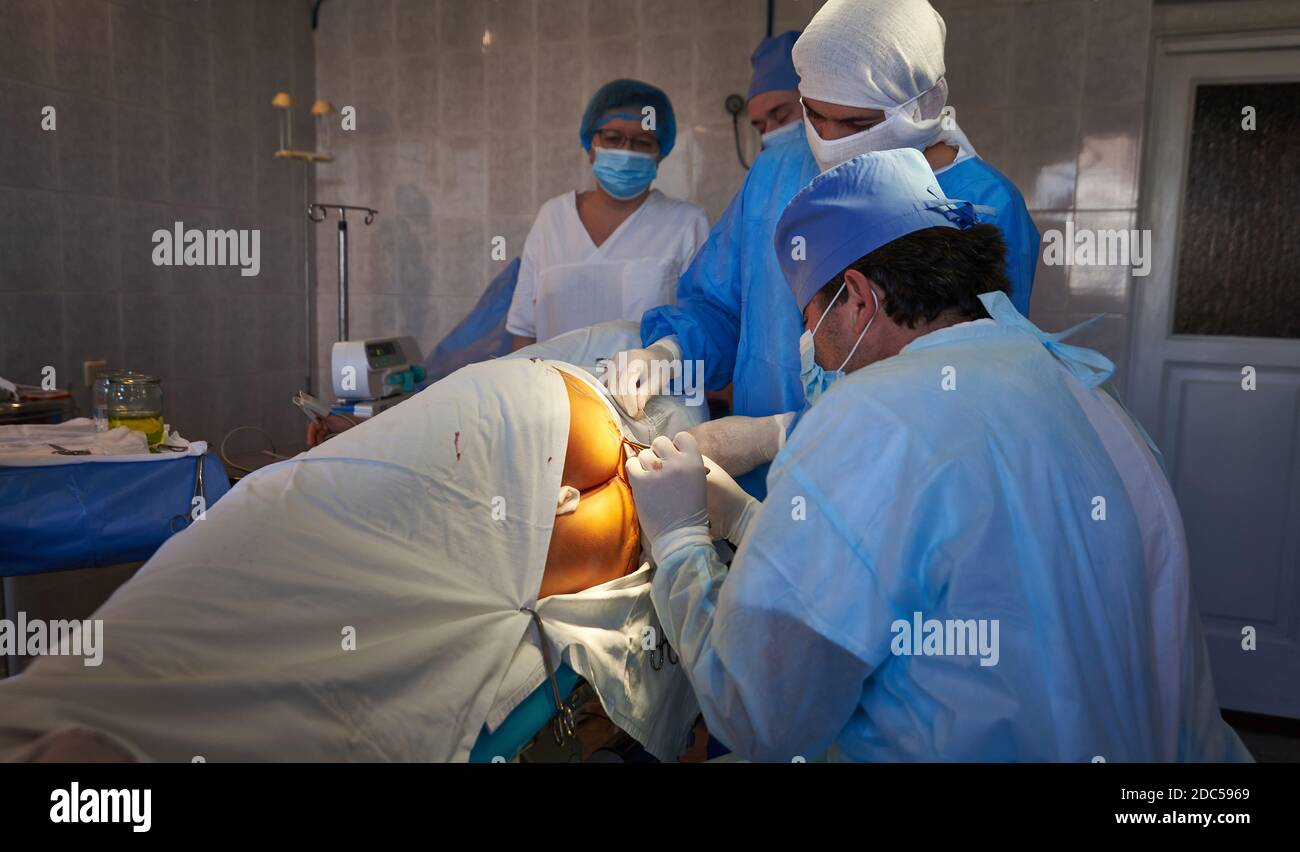 Surgery. The team of surgeons sutures the operating wound. Medical ...