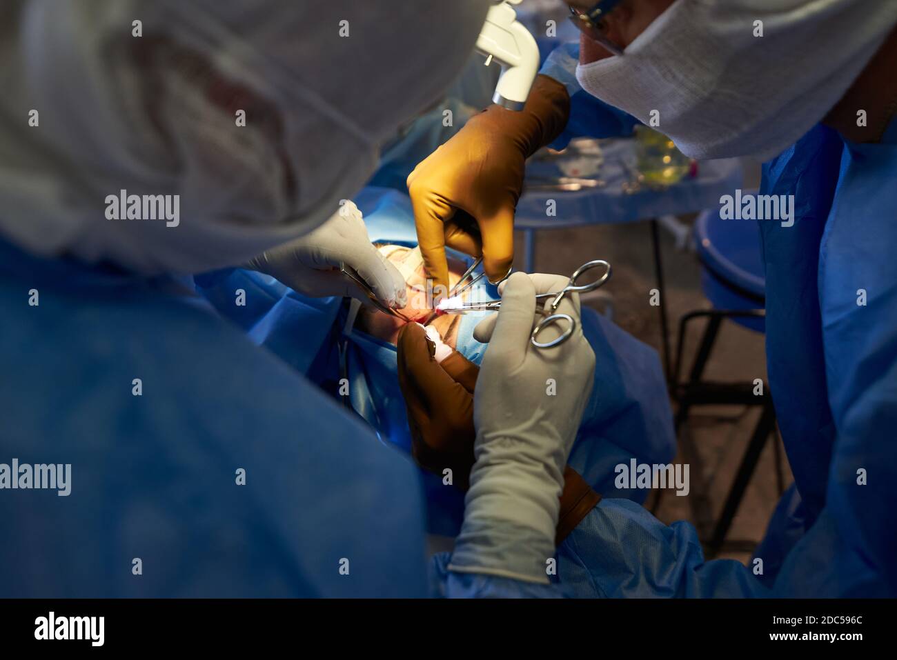 Surgery. Top view of ?perating wound. Hands of surgeons with tools ...