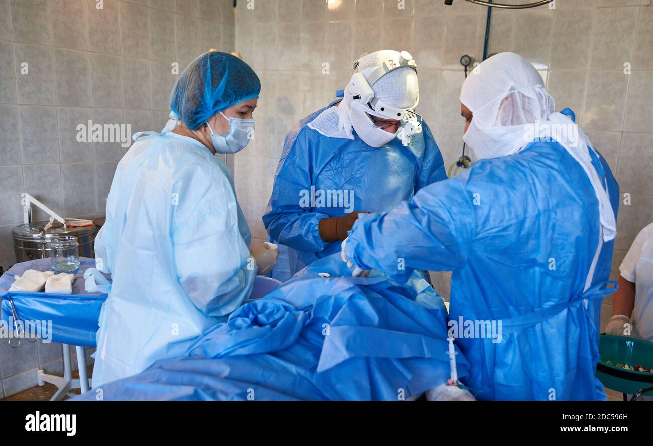 Surgery. View from the patient's legs. Surgical team at work Stock ...