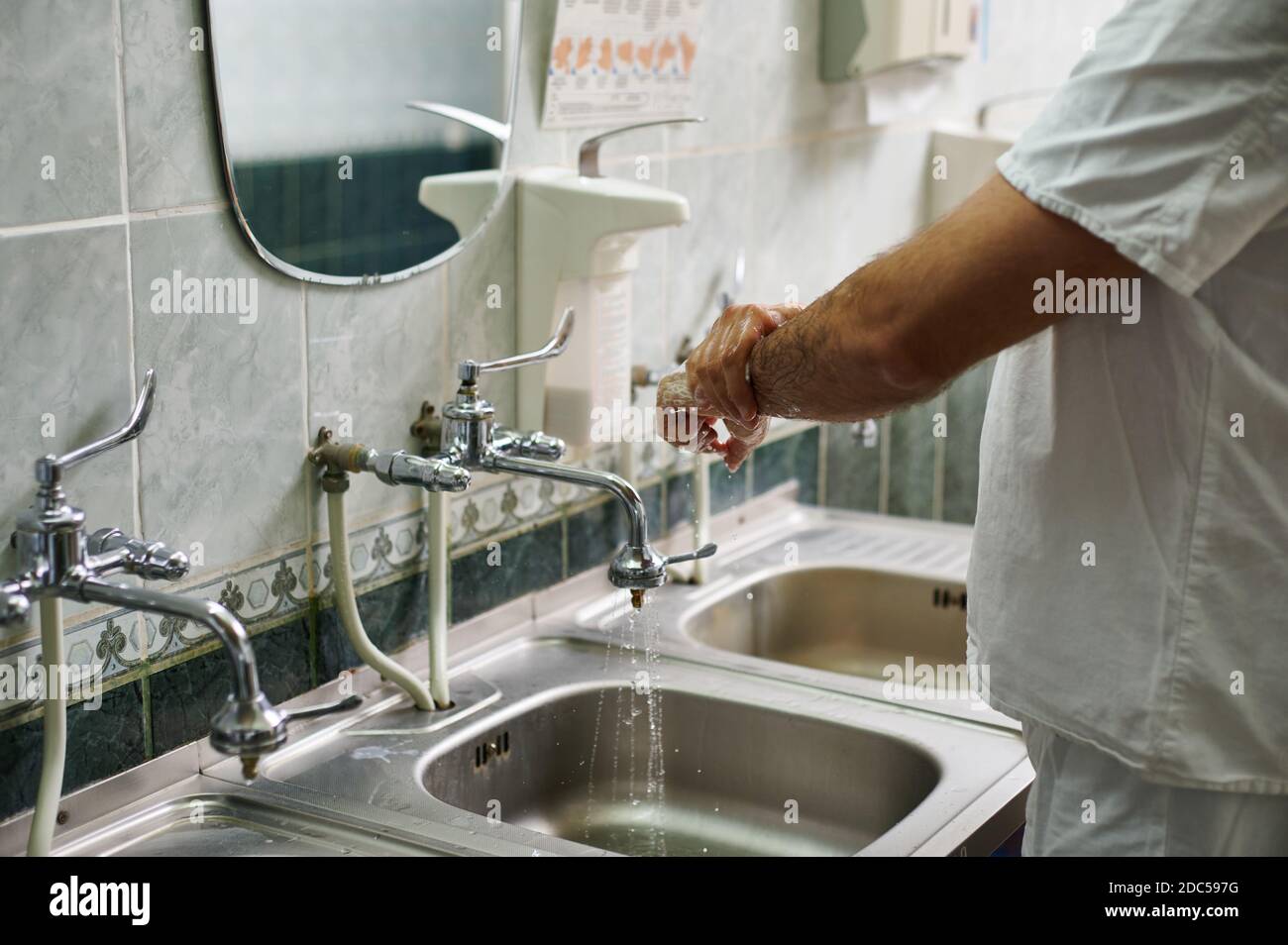 A doctor washes his hands with water in the preoperative room. Hand ...