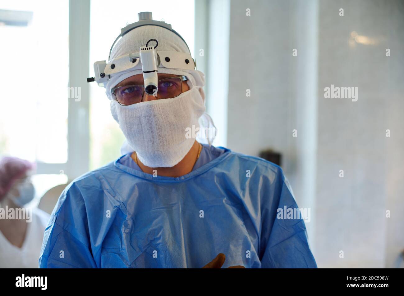 Portrait of a surgeon with a headlamp in the operating room. Before the ...