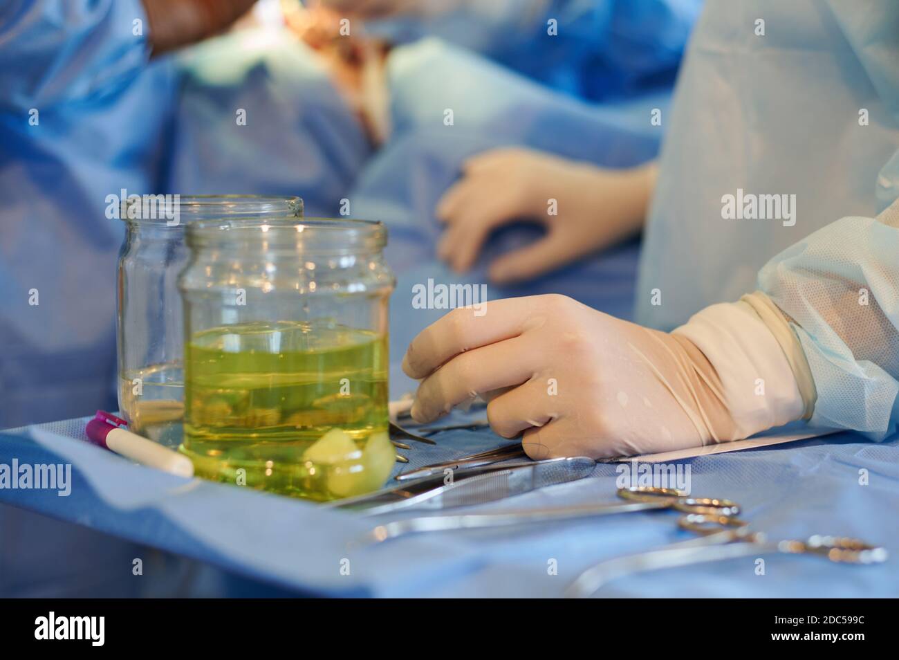 Surgery. Operating room nurse's hand rests on the instrument table ...