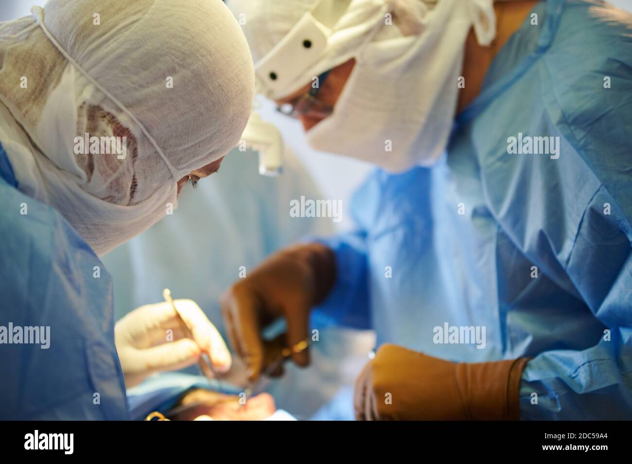 Surgeons perform an operation at an operating theatre hi-res stock ...