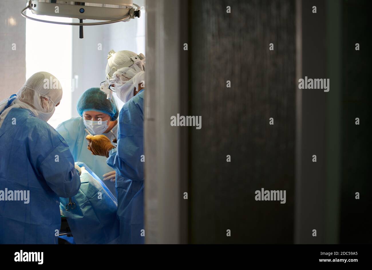 Surgery. Operation is in progress. View from behind the operating room ...