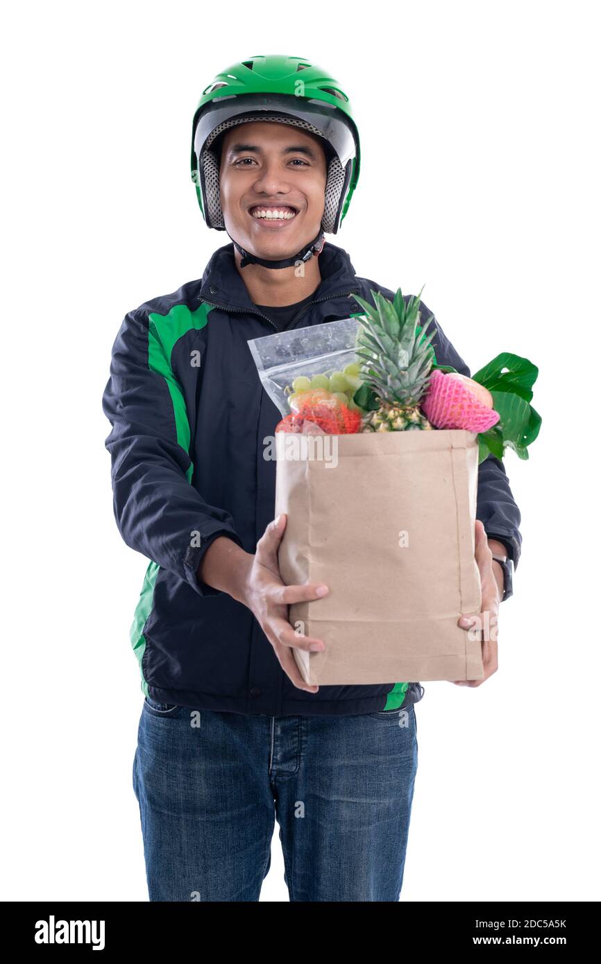 grocery delivery. courier wearing helmet and jacket uniform holding ...