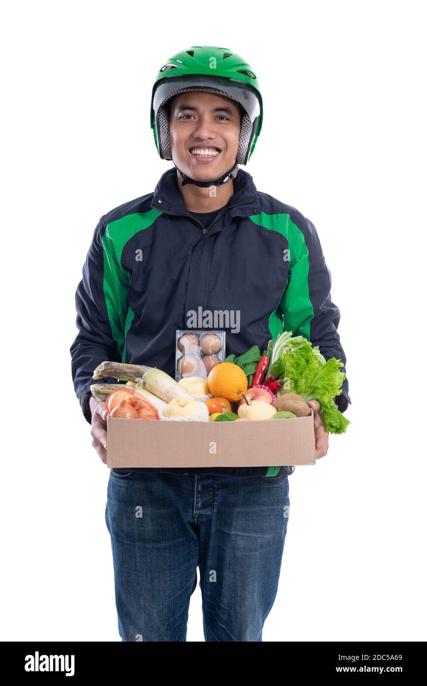 grocery delivery. courier wearing helmet and jacket uniform holding ...