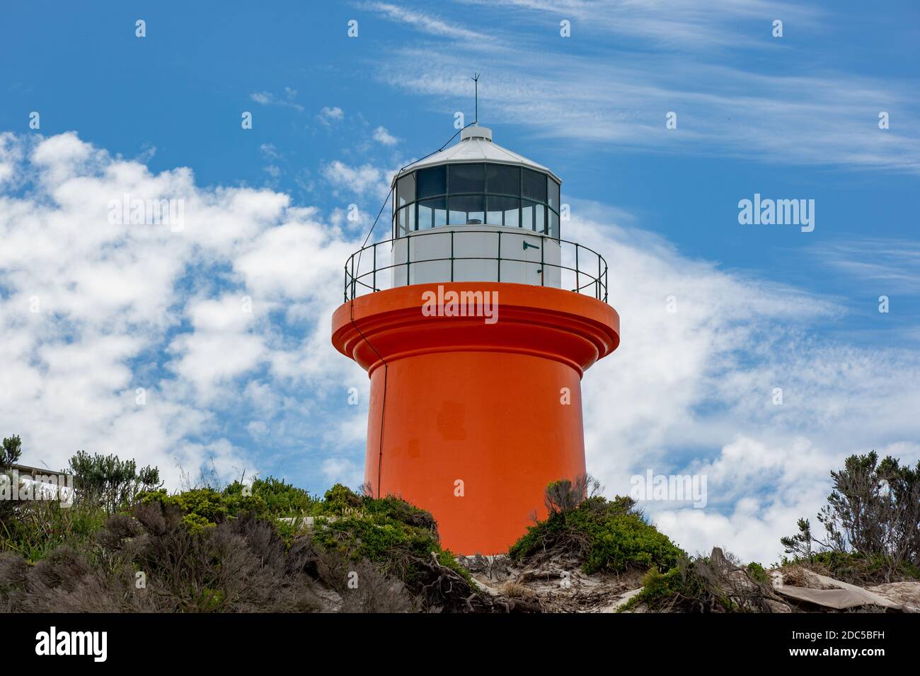 The iconic red Cape banks lighthouse with blue sky and white clouds ...