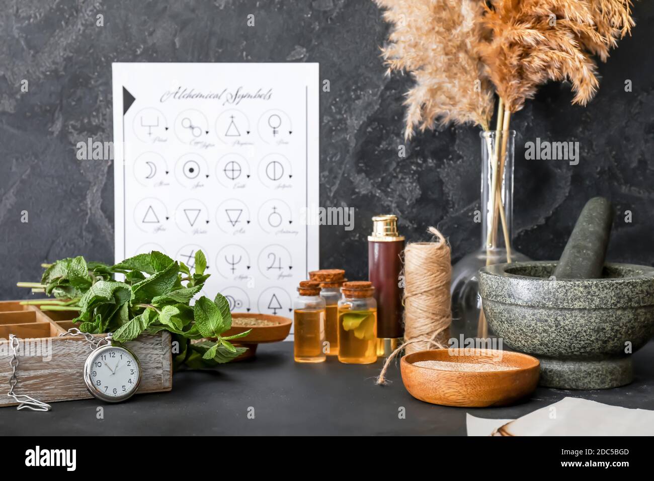 Alchemical symbols and ingredients for preparing potions on dark ...