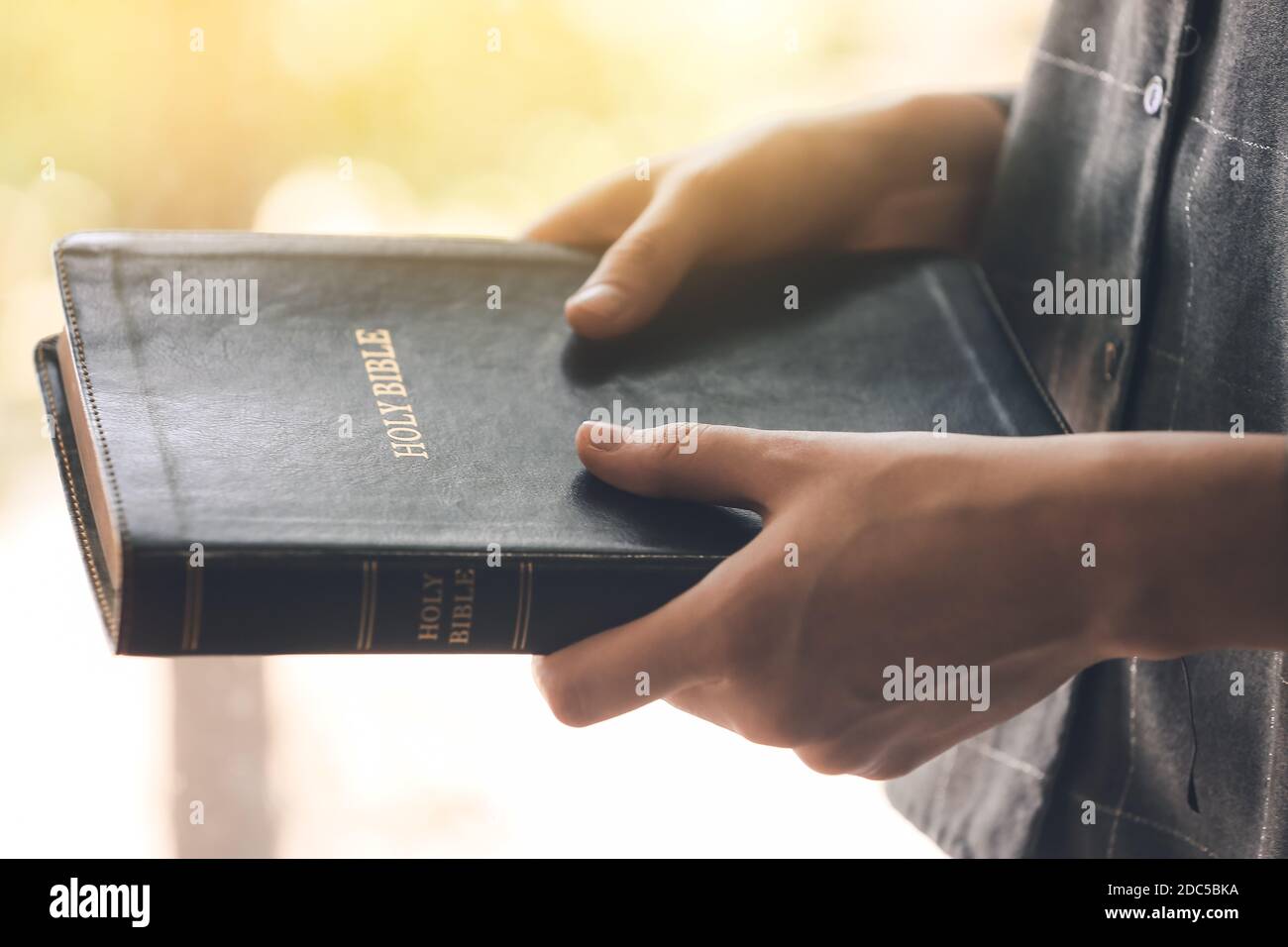 Man holding Holy Bible, closeup Stock Photo - Alamy