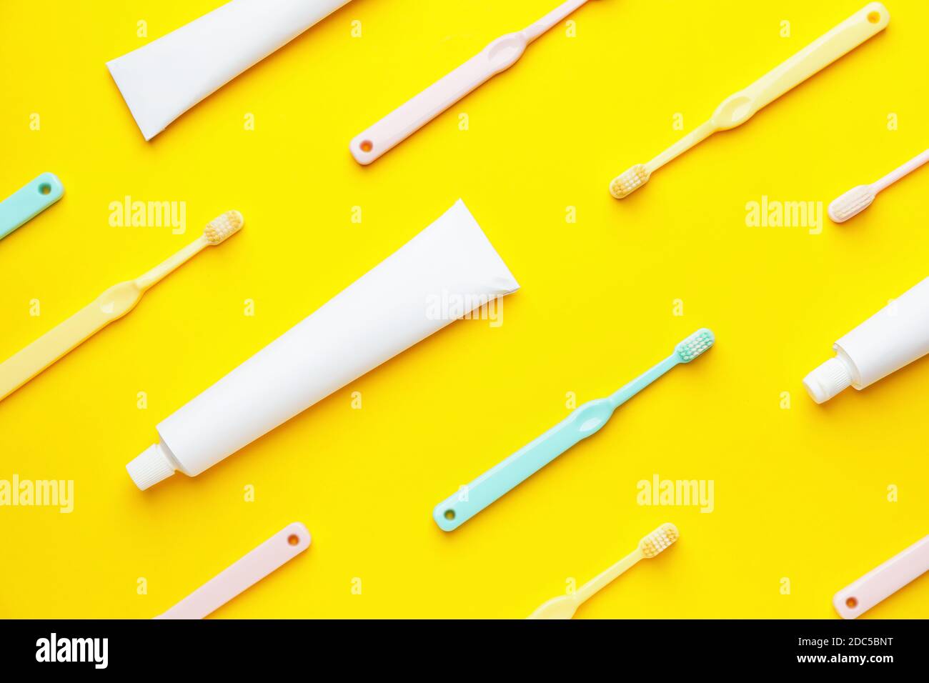 Toothbrushes and paste on color background Stock Photo - Alamy