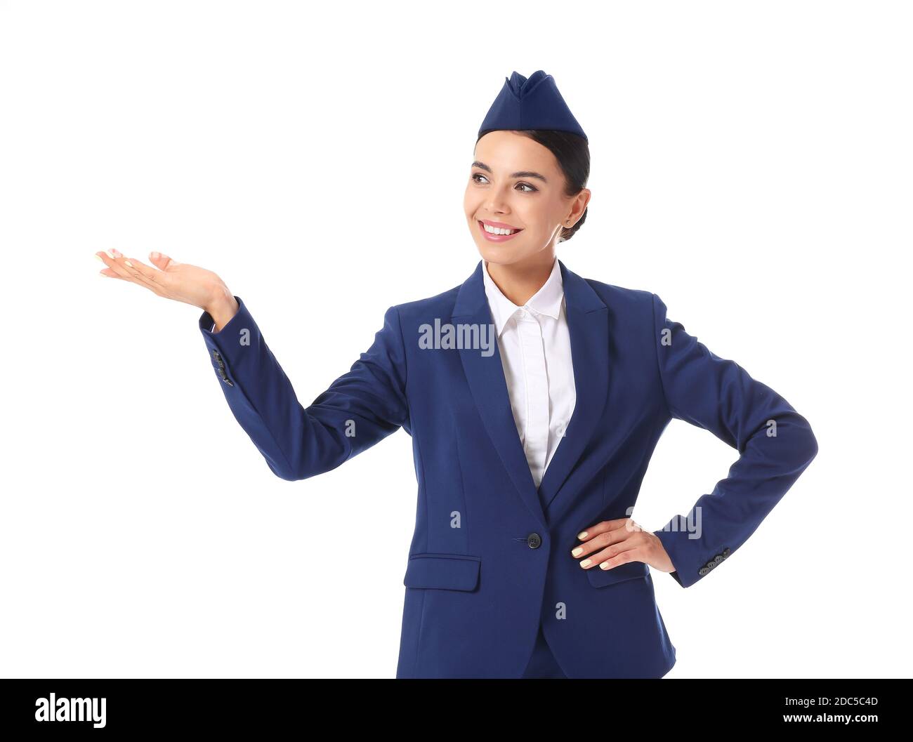 Beautiful stewardess showing something on white background Stock Photo ...