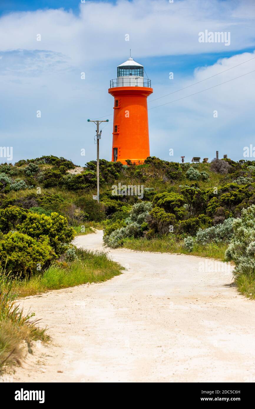 The iconic red Cape banks lighthouse and the access road with selective ...