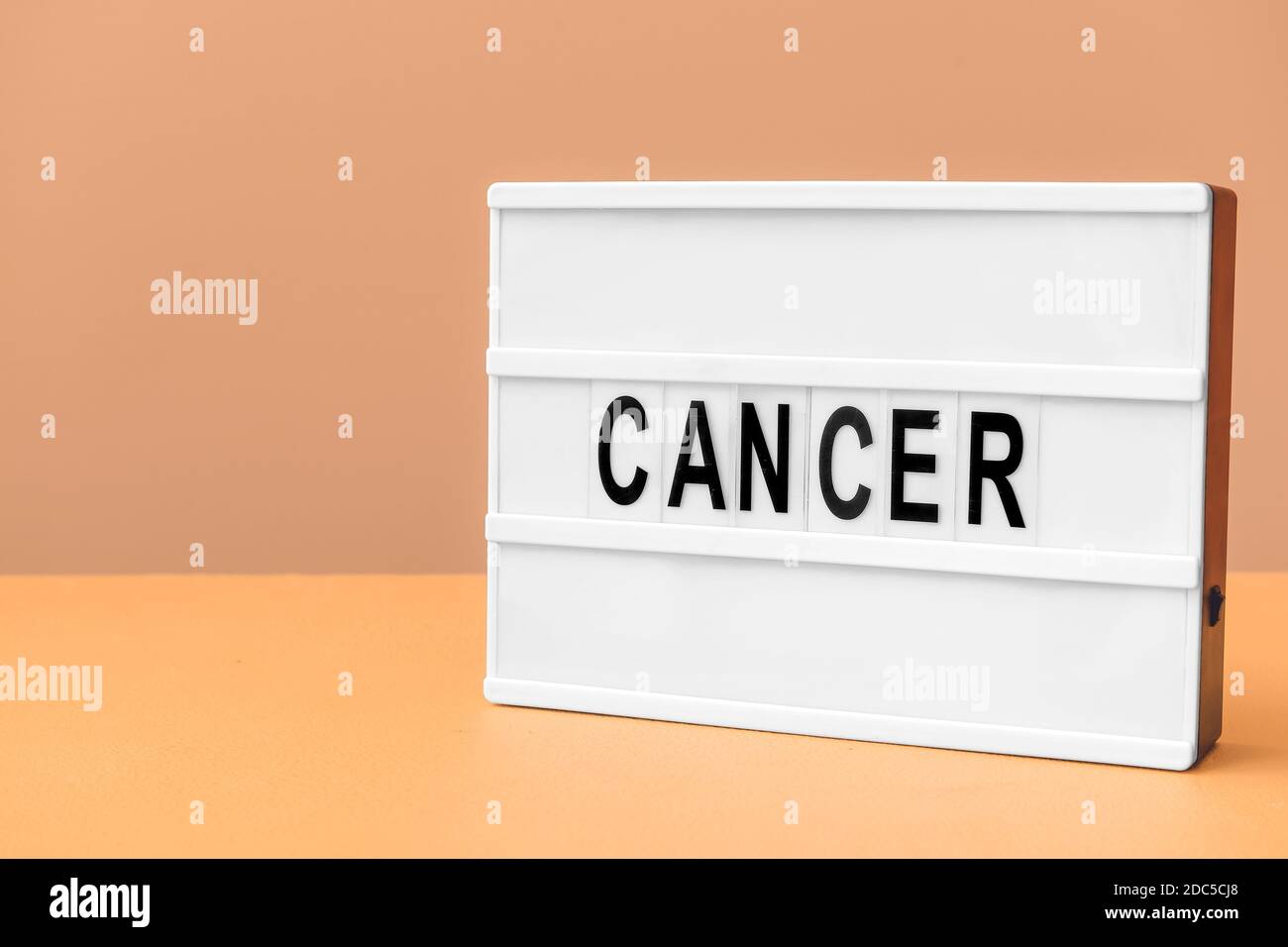 Board with word CANCER on color background Stock Photo - Alamy