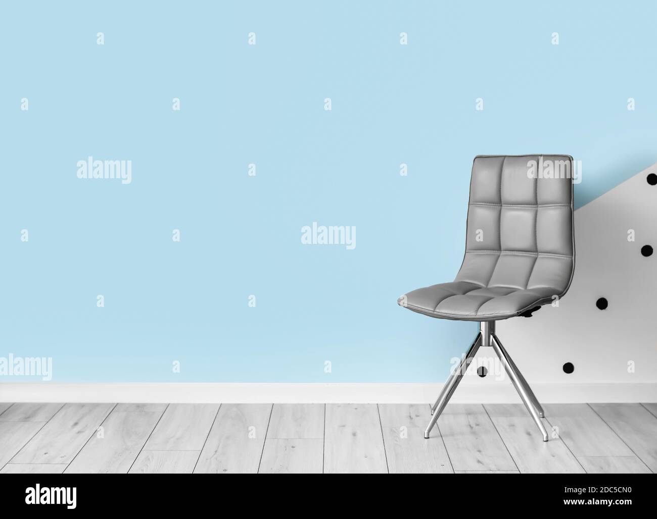 Chair near color wall in room Stock Photo - Alamy