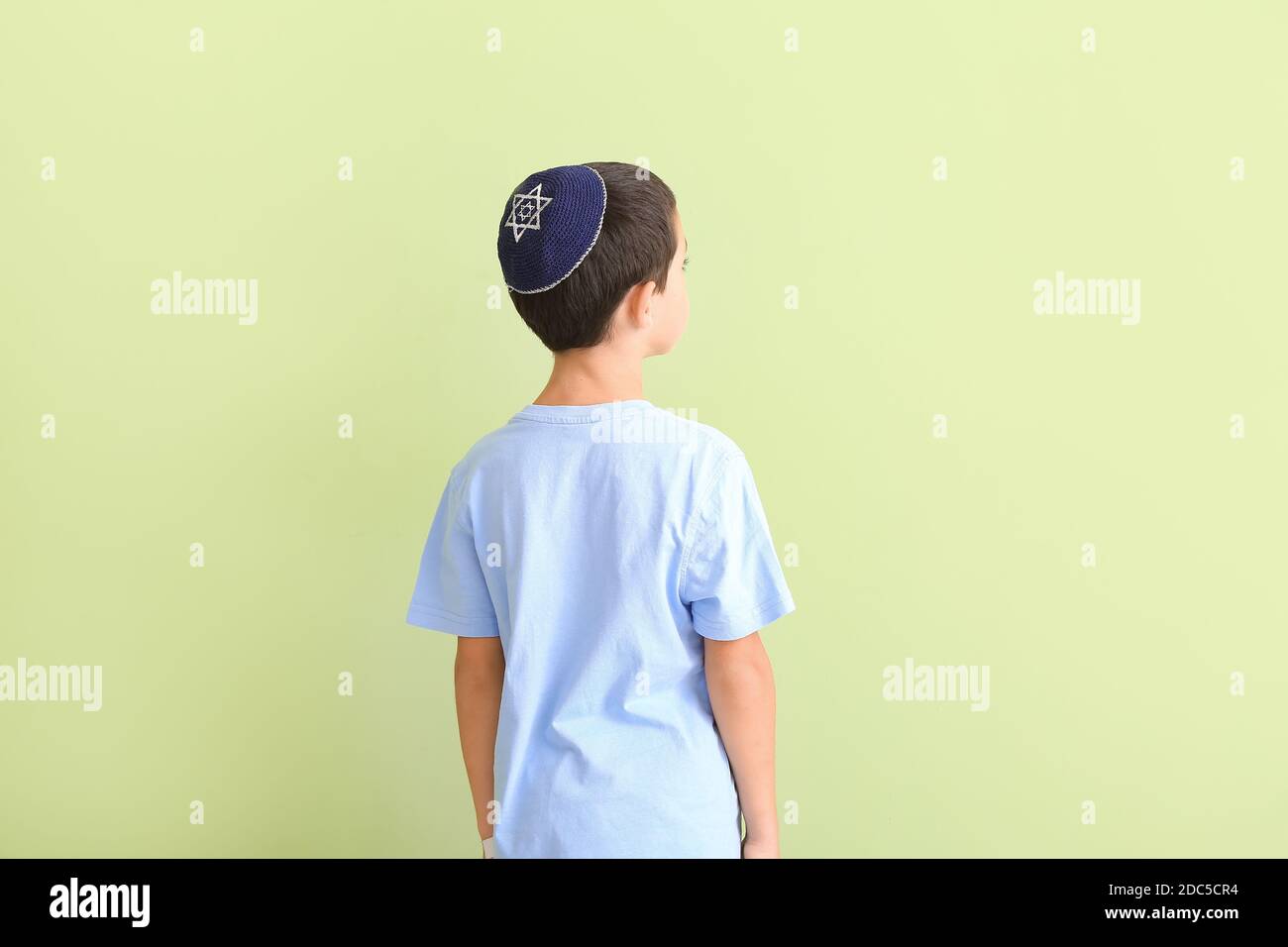 Cute Jewish boy on color background Stock Photo - Alamy