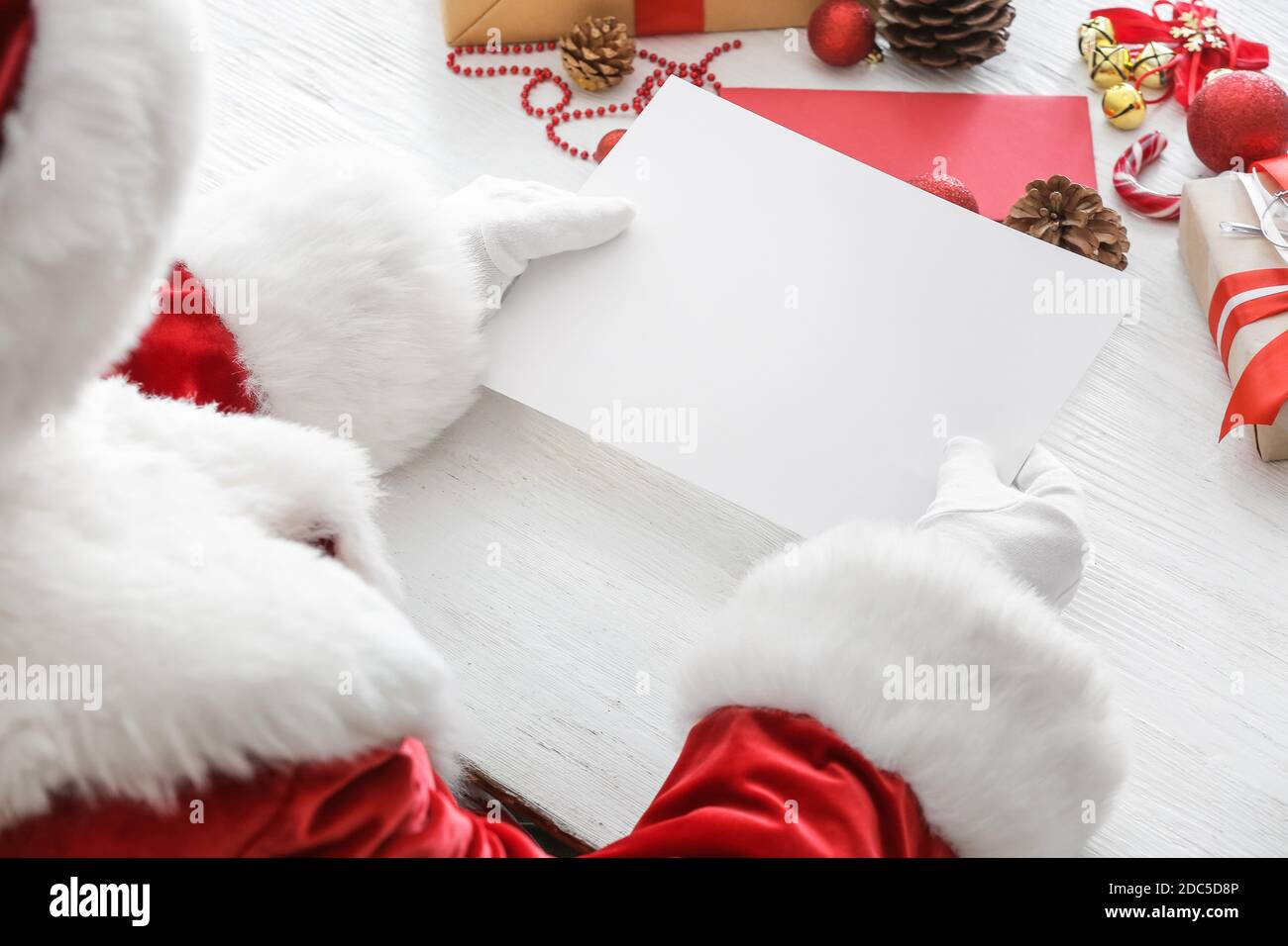 Santa Claus with empty letter at table Stock Photo - Alamy