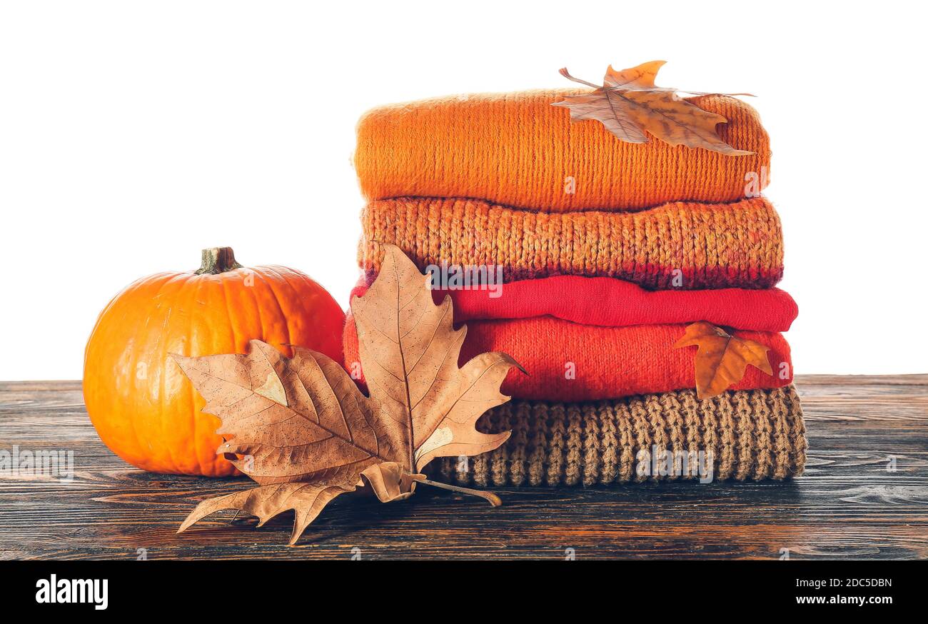 Stylish autumn clothes on table against white background Stock Photo ...
