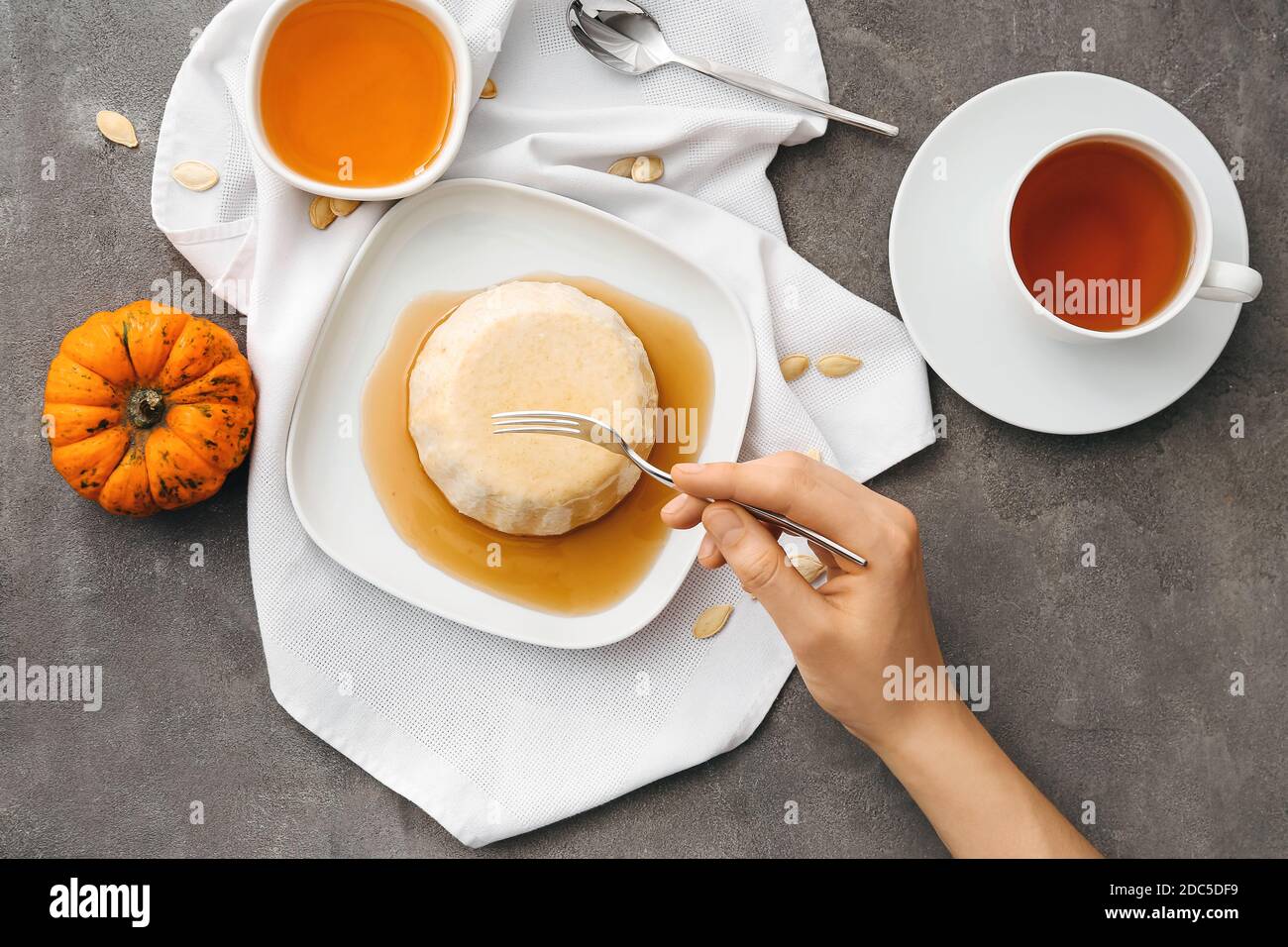 Woman eating tasty pumpkin pudding from plate Stock Photo - Alamy
