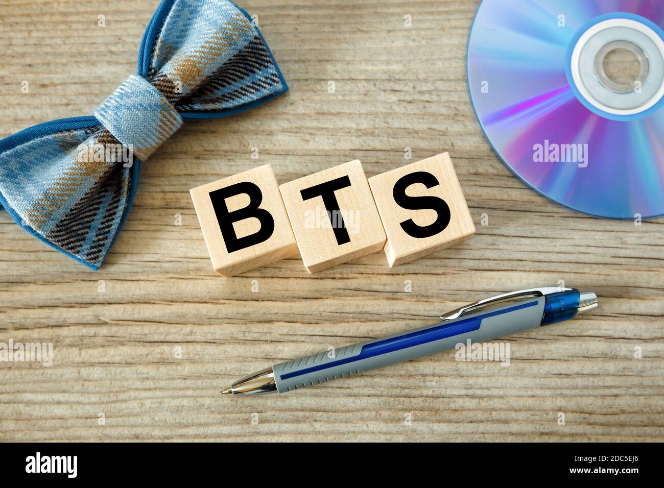 BTS concept with wooden cubes. BTS word on CD background, bow tie and ...