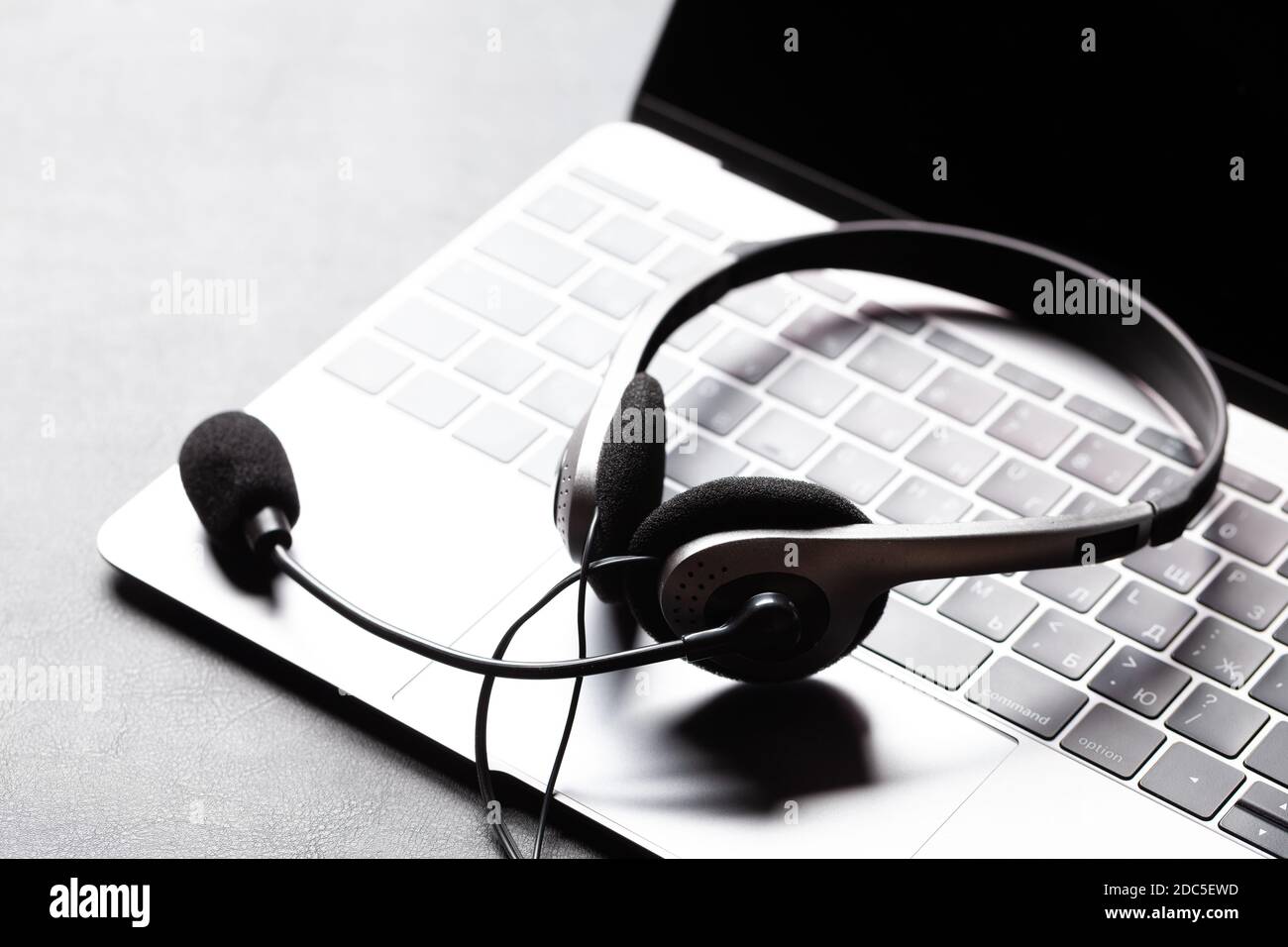 Office desk with headset and laptop. Remote office and work from home ...