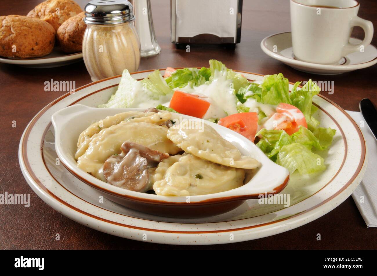 Chicken portabella mushroom ravioli with alfredo sauce and salad Stock ...