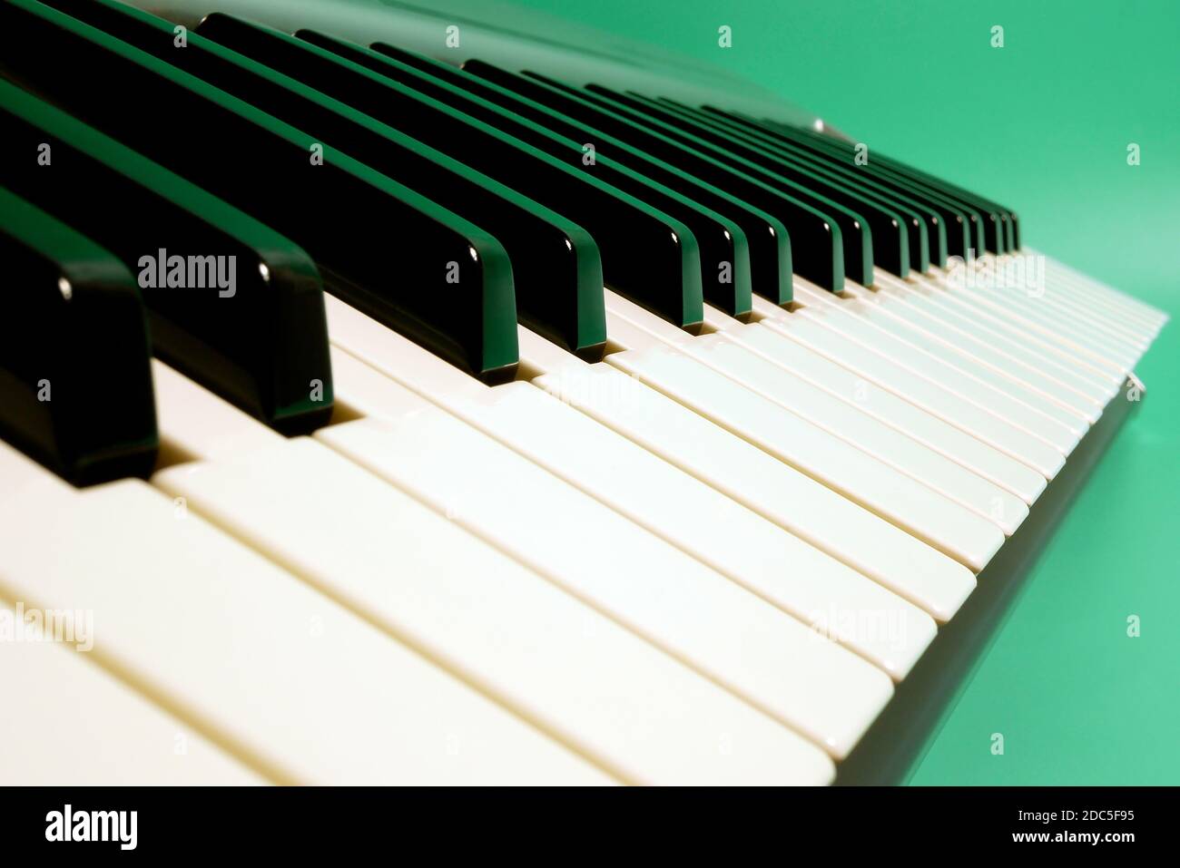 Close up of musical keyboard synthesizer on turquoise background. Focus ...