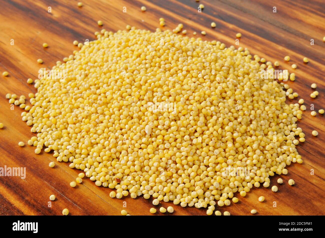 A mound of hulled millet on a chopping block Stock Photo - Alamy