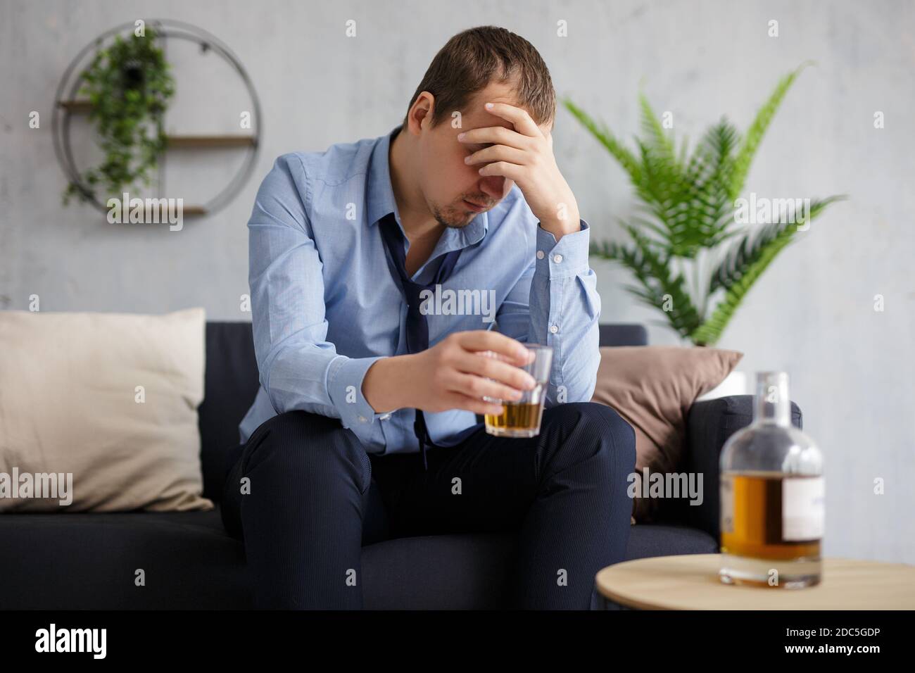 business and stress concept - depressed and tired businessman drinking ...