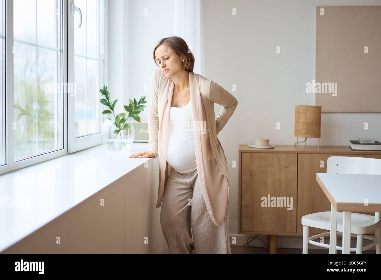 Healthcare, treatment. Young pregnant woman feeling sudden pain in her ...