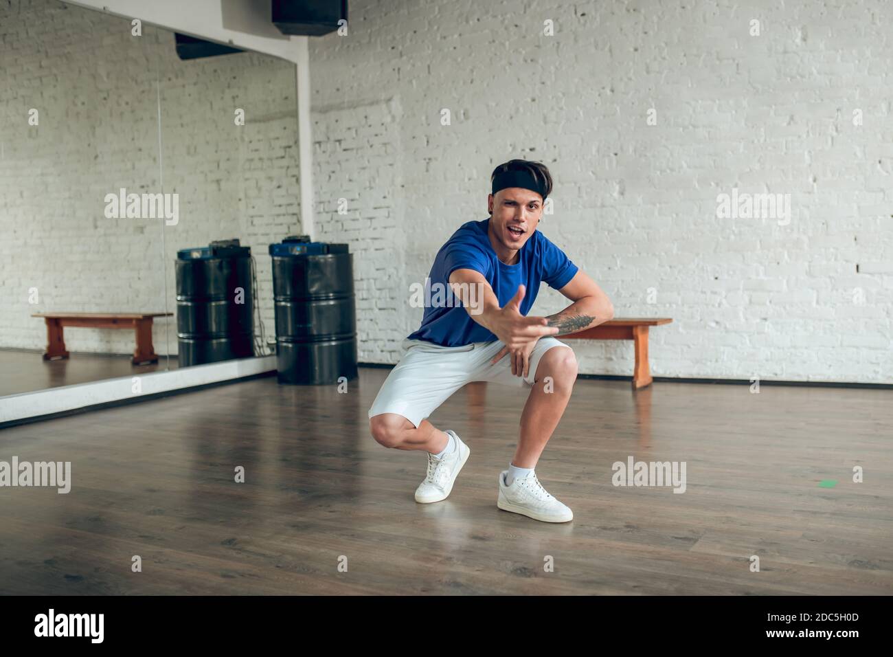Man performing sit up while doing dance routine Stock Photo - Alamy
