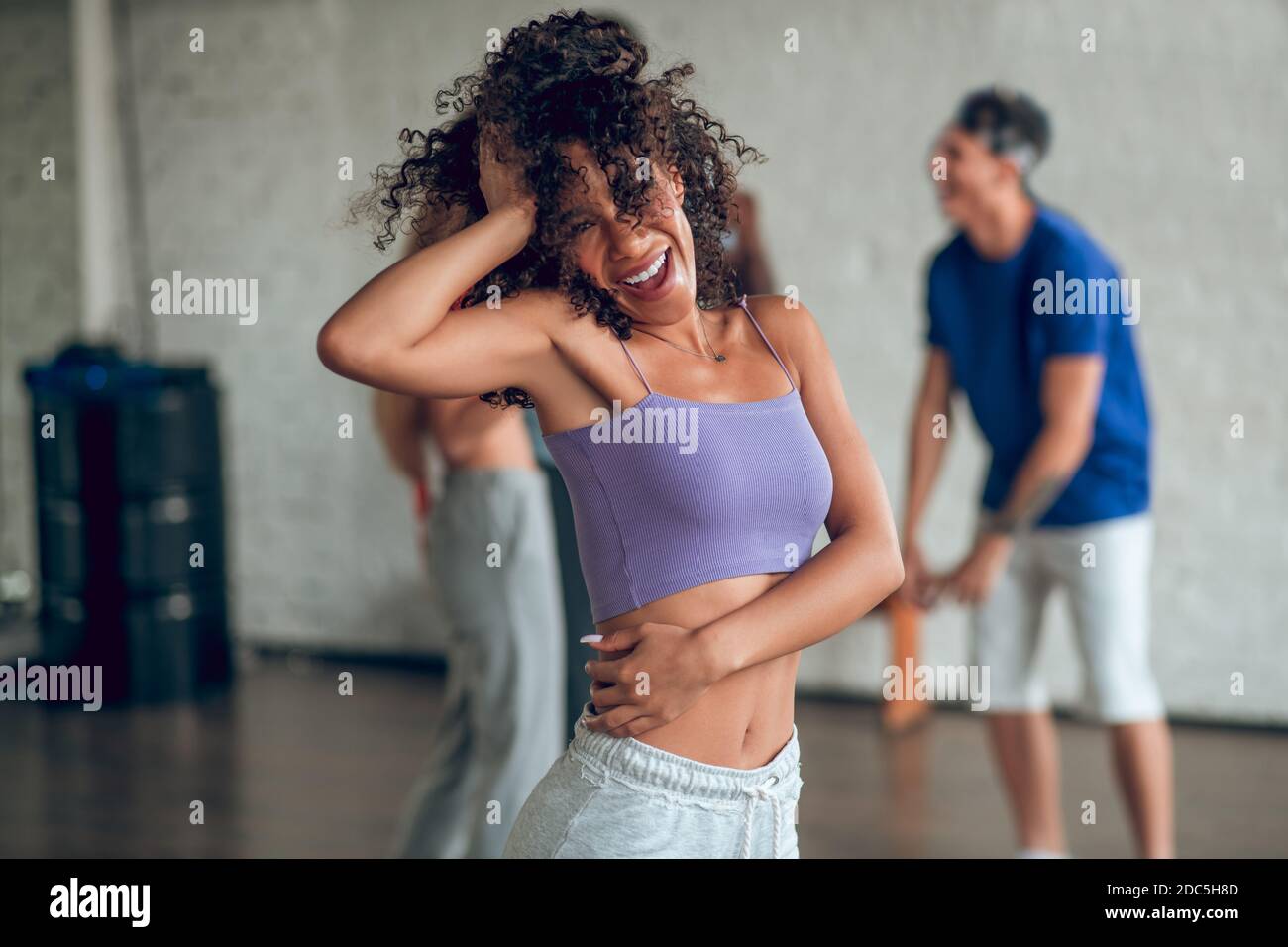 Emotional and energetic woman having a dance class Stock Photo - Alamy