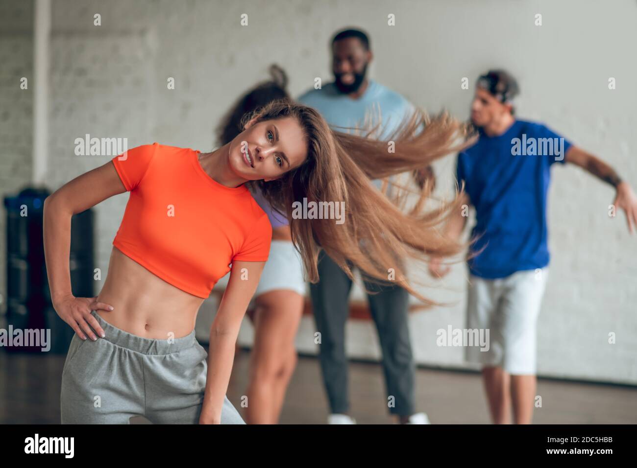 Smiling and confident woman making dance movements Stock Photo - Alamy
