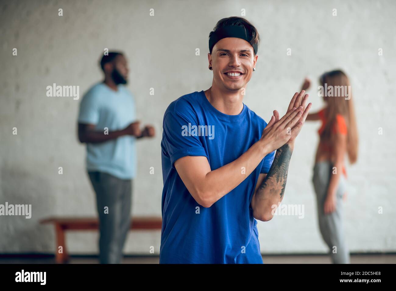Man clapping his hands while teaching dancing Stock Photo - Alamy