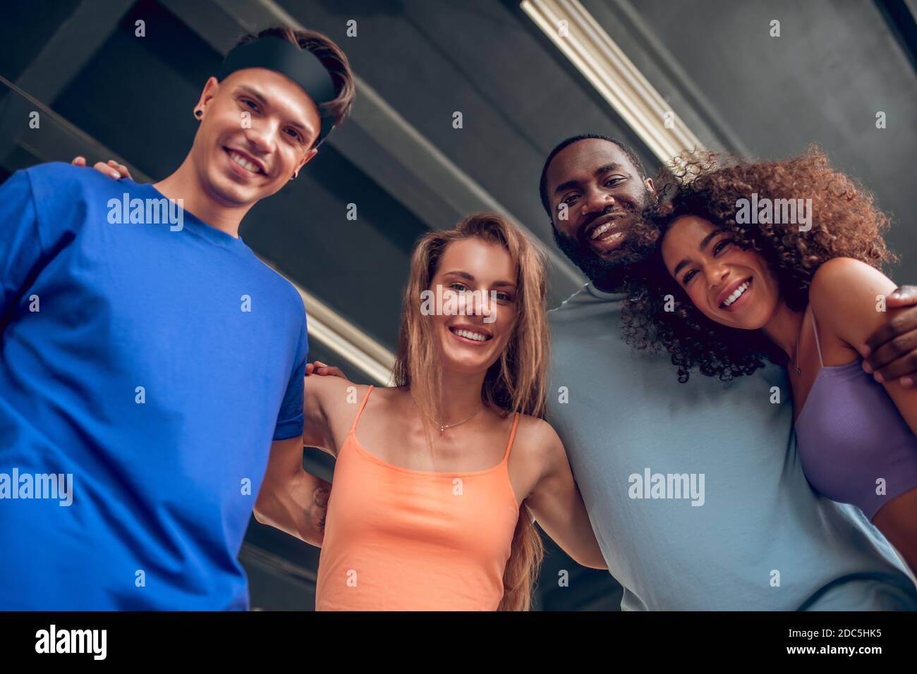 Good team hugging each other and feeling support Stock Photo - Alamy