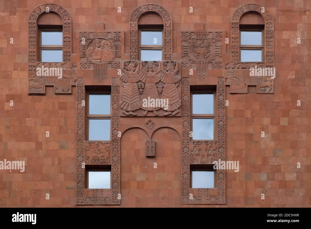 Frieze decorates facade of a soviet era building constructed from rosy ...