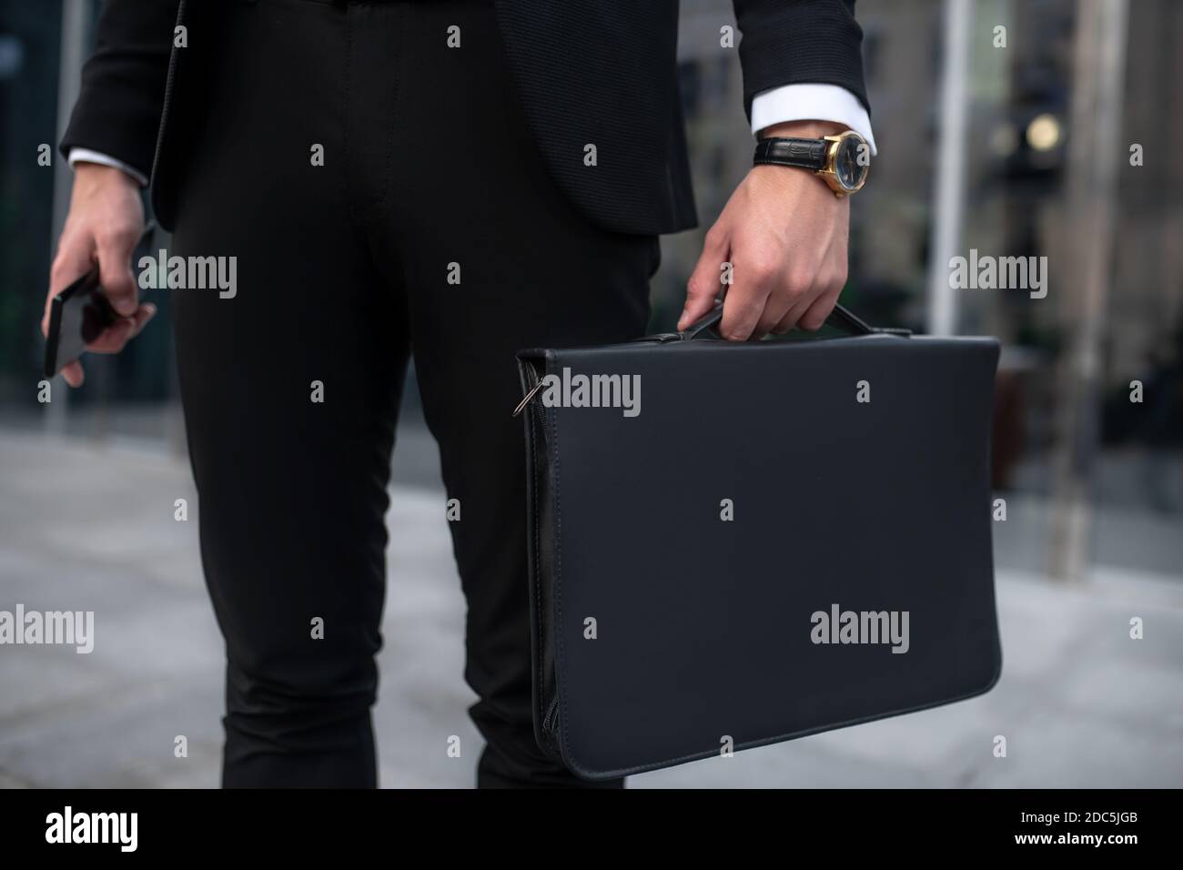 Close up picture of a man with portfolio in his hand Stock Photo - Alamy