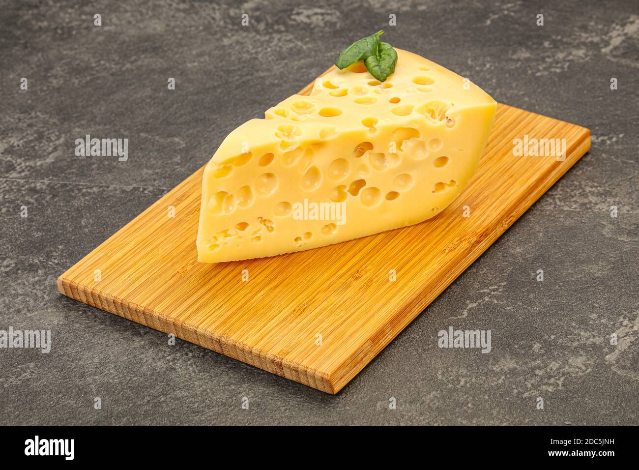 Maasdam cheese - dairy yellow triangle with holes Stock Photo - Alamy